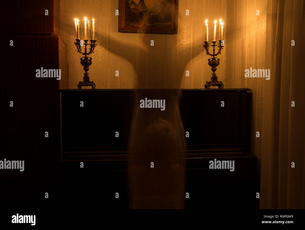Ghost woman in room with candles Stock Photo - Alamy