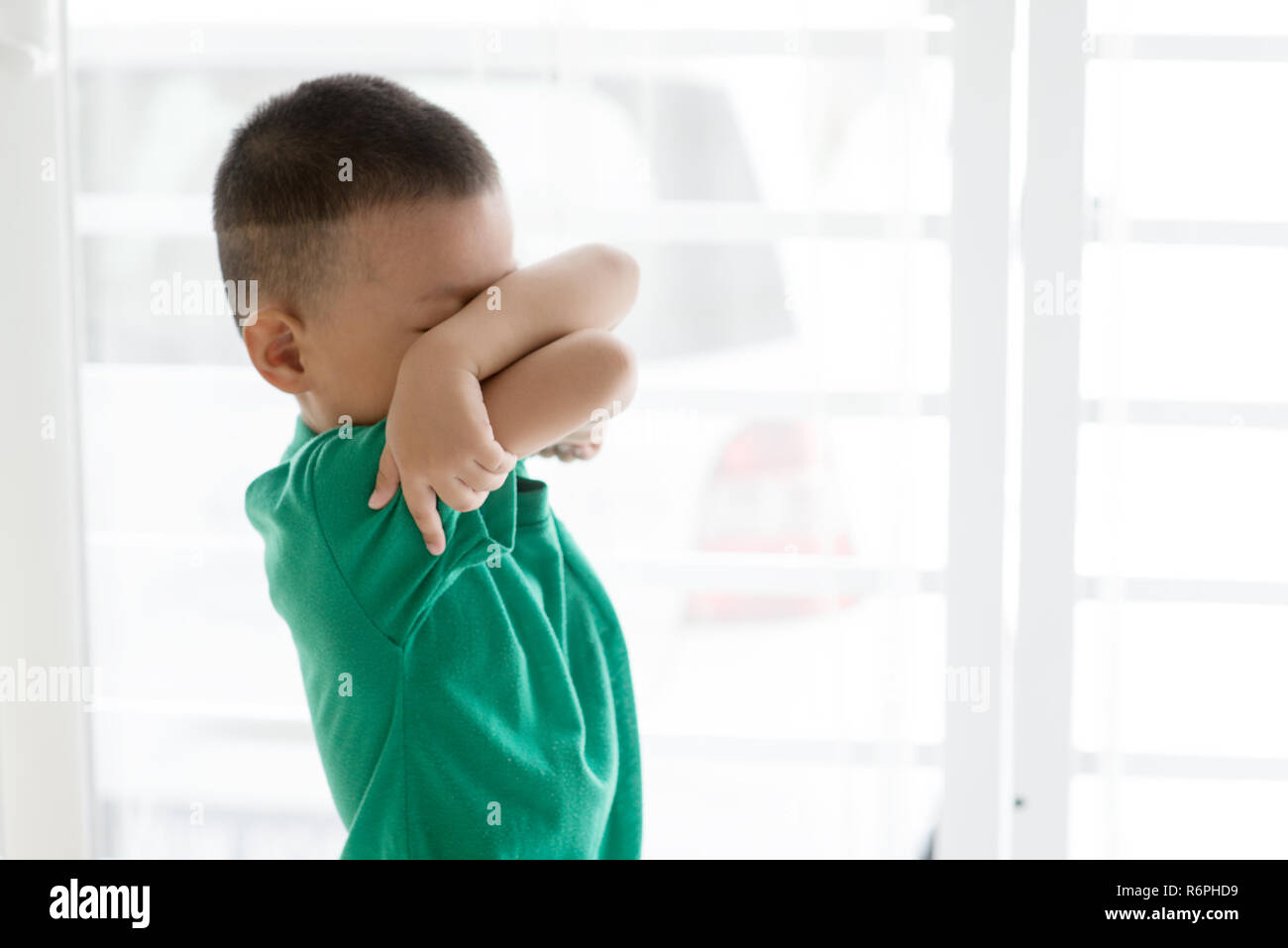 Boy covering face Stock Photo - Alamy