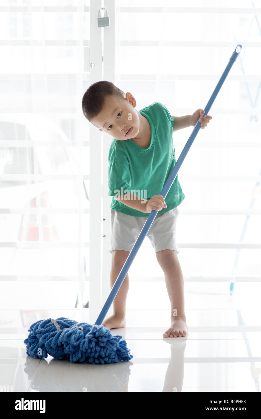 Asian child mopping floor Stock Photo - Alamy