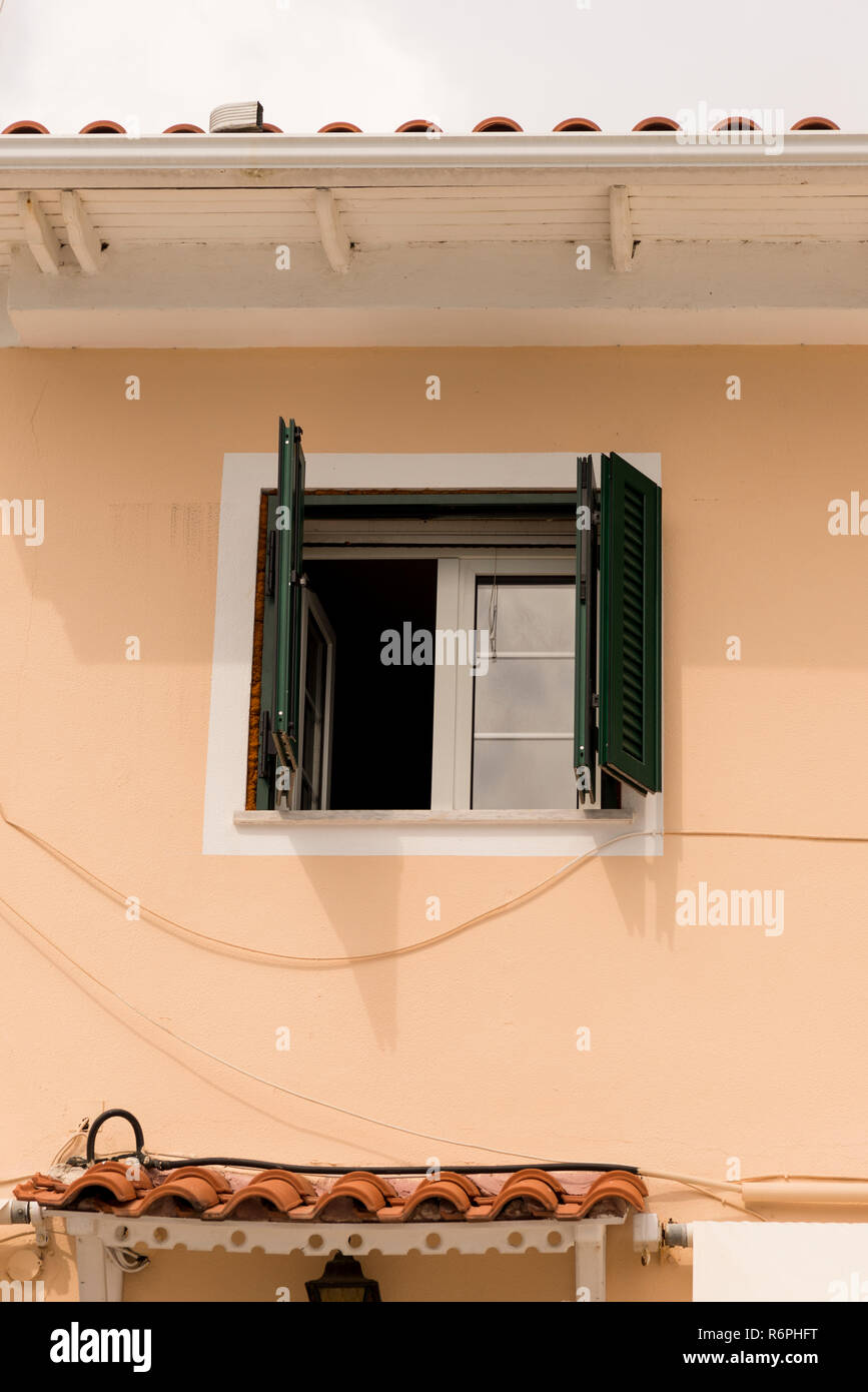 Green blinds opened window on a beige wall Stock Photo - Alamy