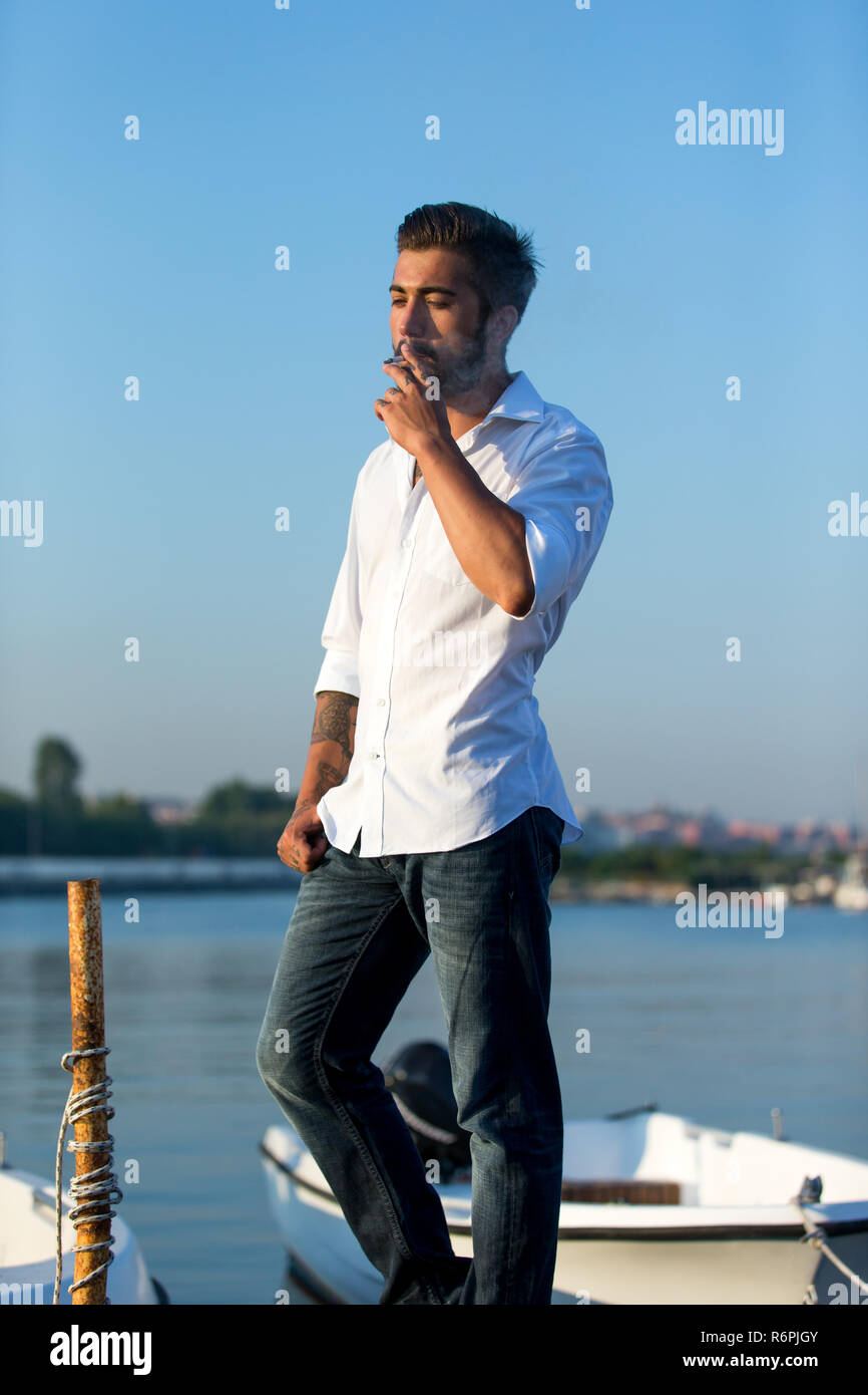 Man smoking rowing boat hi-res stock photography and images - Alamy