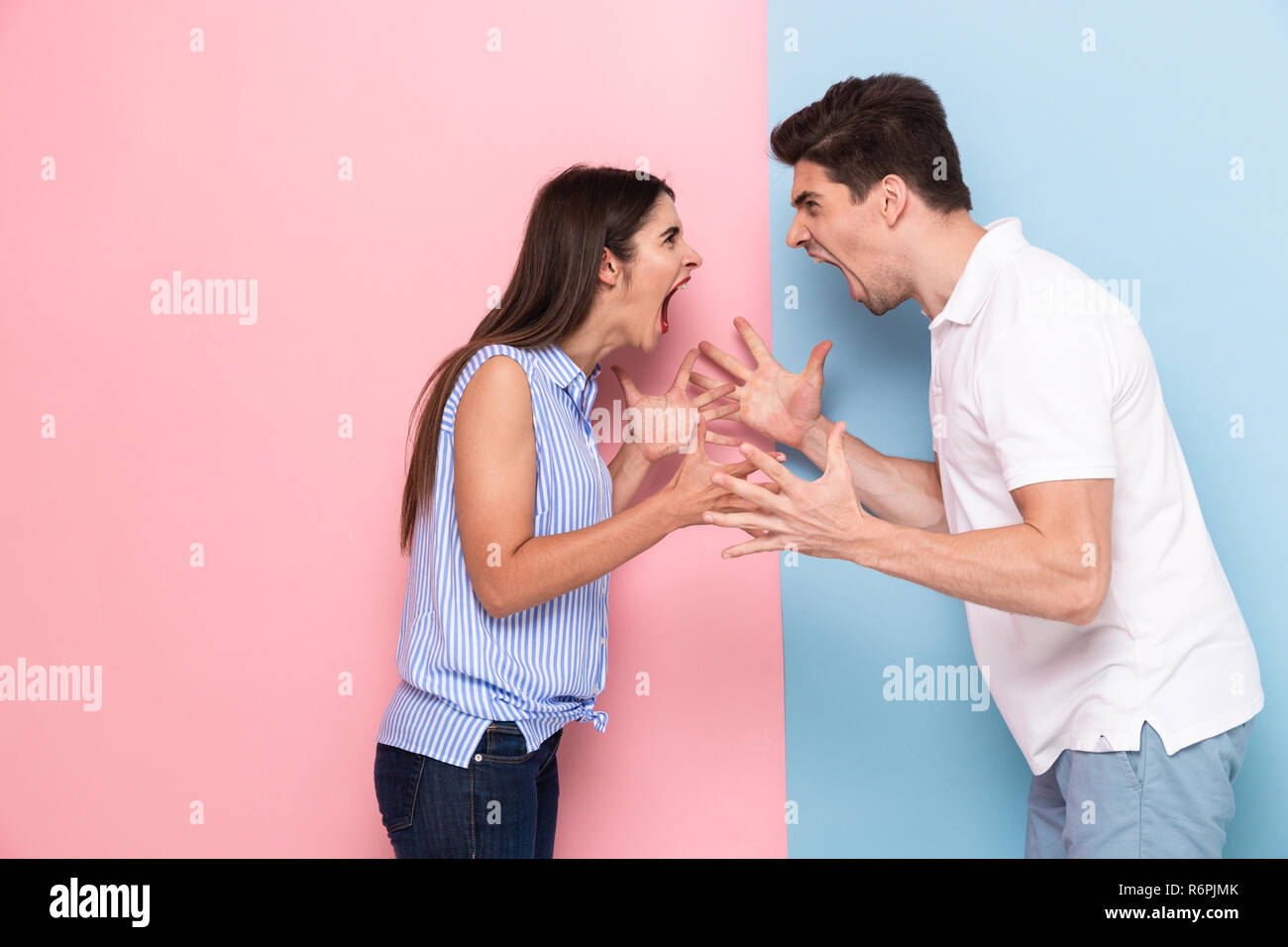 Photo of angry man and woman in casual clothes screaming at each other ...