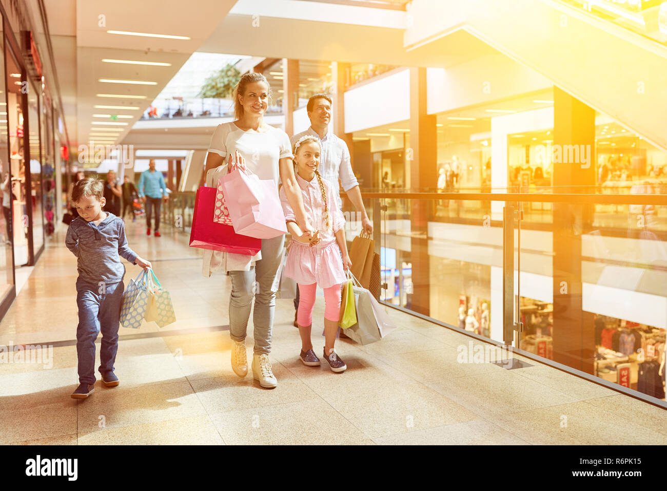 Family shopping with two children in shopping mall Stock Photo - Alamy