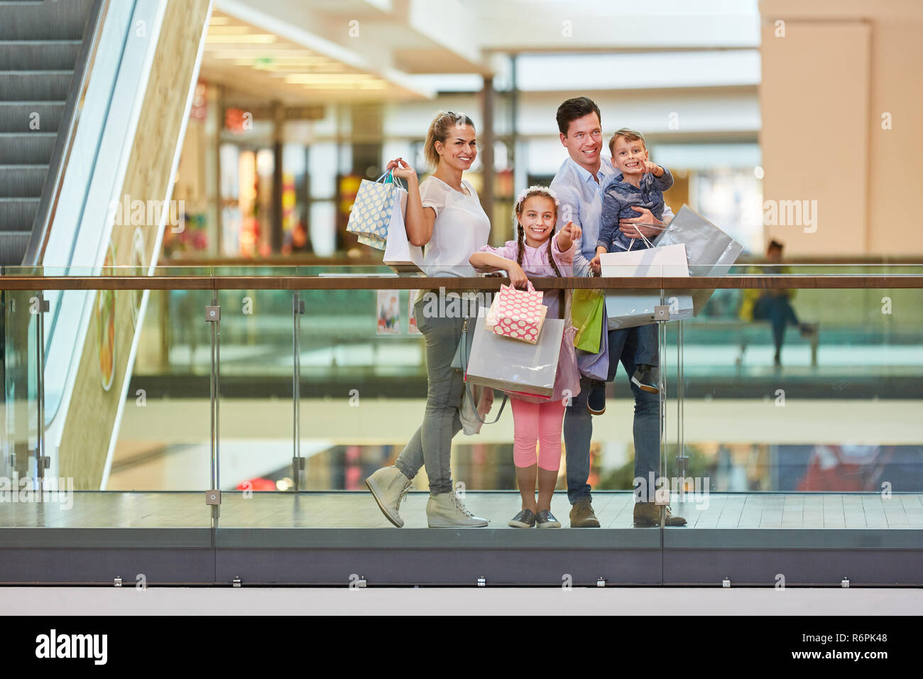 Happy family shopping at the weekend in the shopping center Stock Photo ...