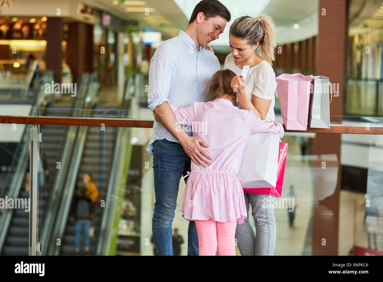 Happy family and kid together in shopping mall while shopping Stock ...