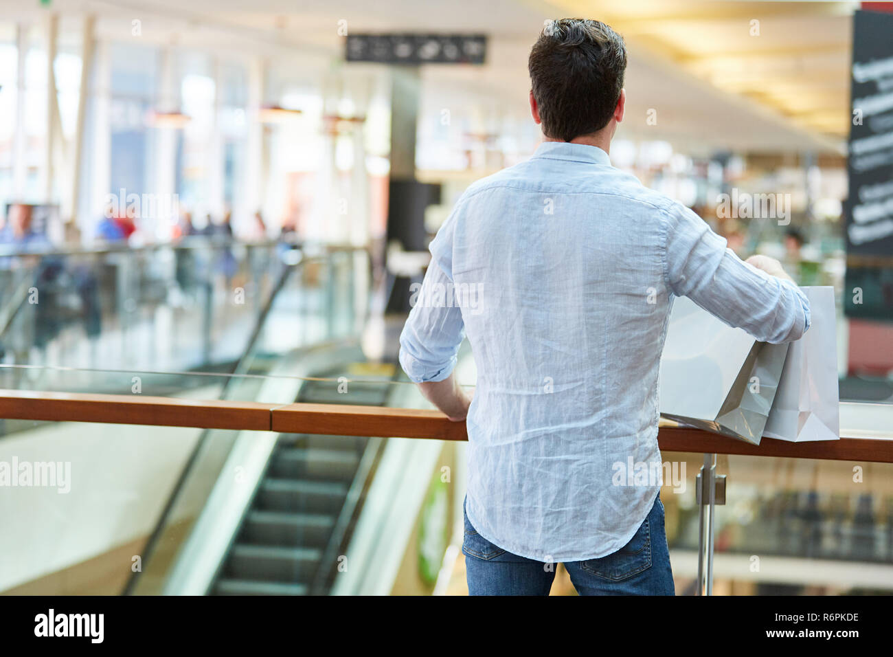 Man as a consumer and customer in a shopping mall while shopping Stock ...