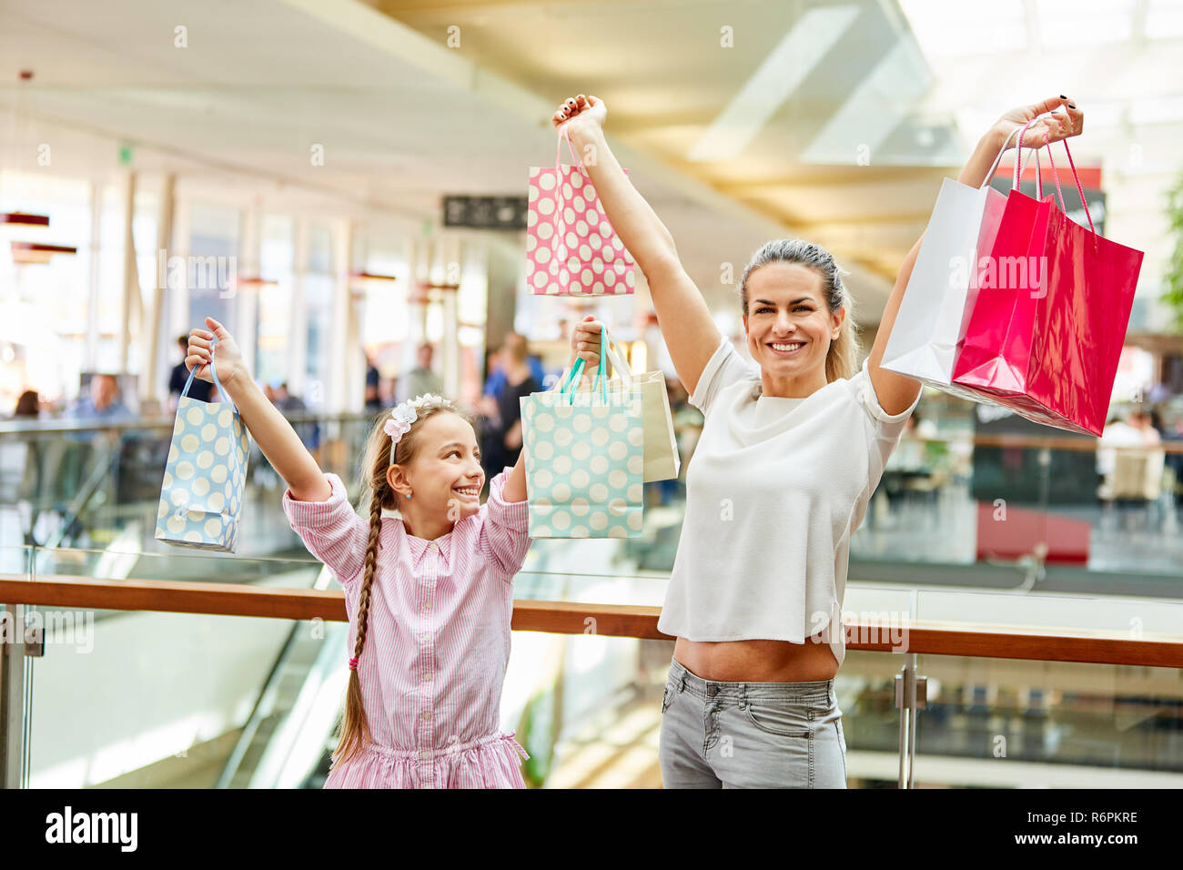 Mother and daughter shopping at the mall with many shopping bags Stock ...