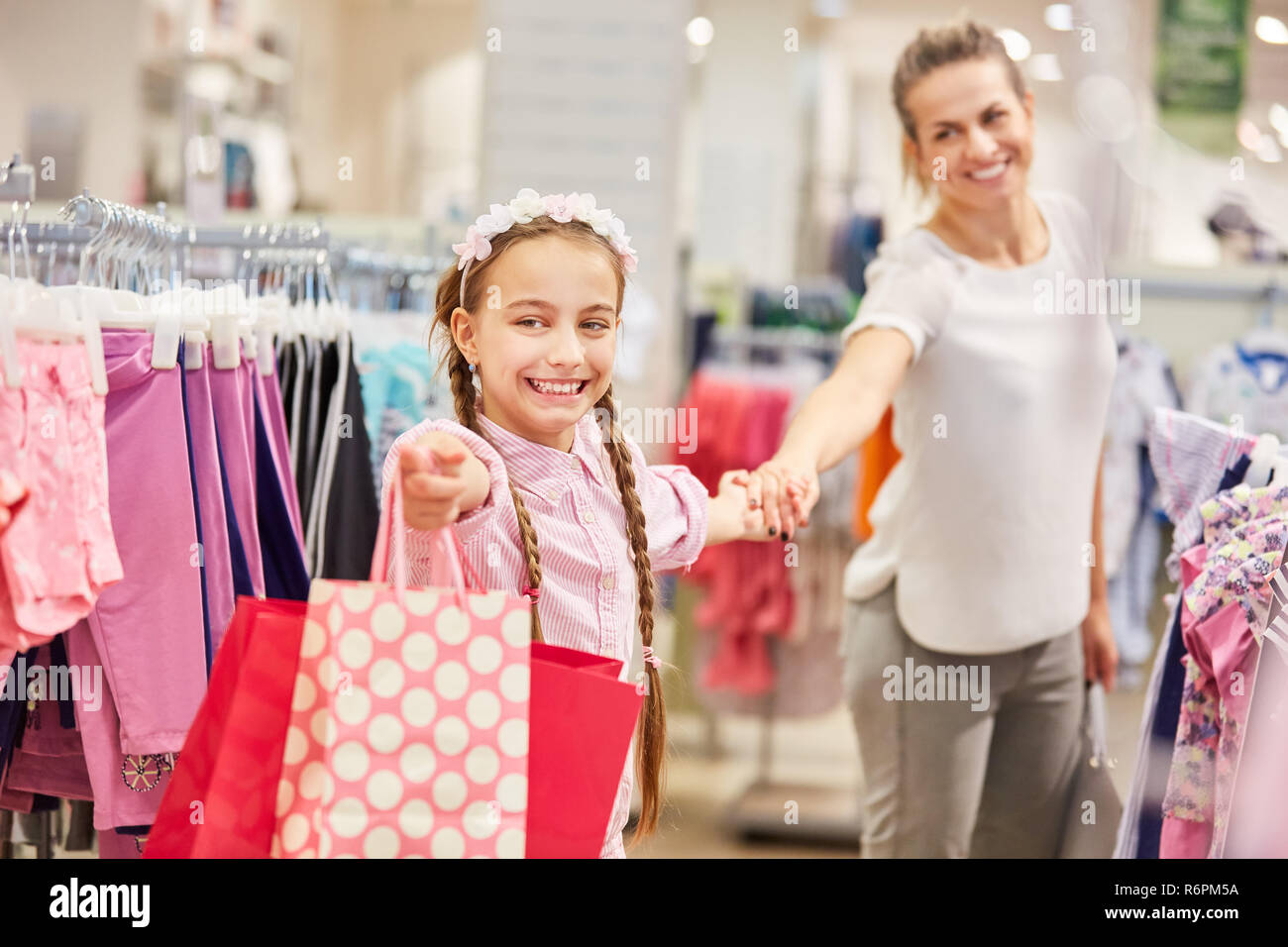 Mother and daughter enjoy shopping in a fashion boutique Stock Photo ...