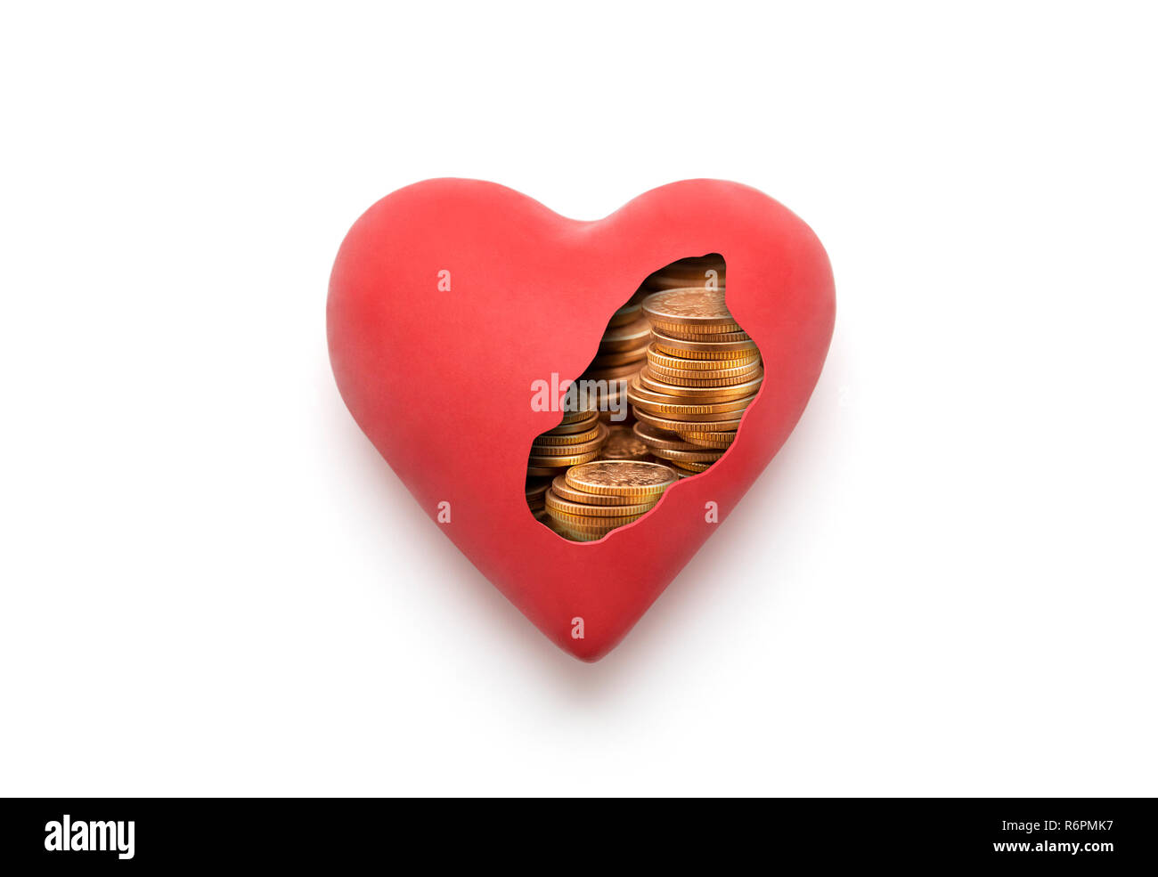 Red heart with golden coins over white background with clipping path ...