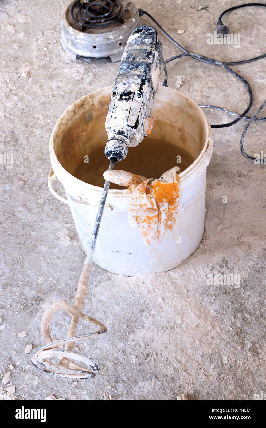 Plaster mixer bucket and glove Stock Photo - Alamy