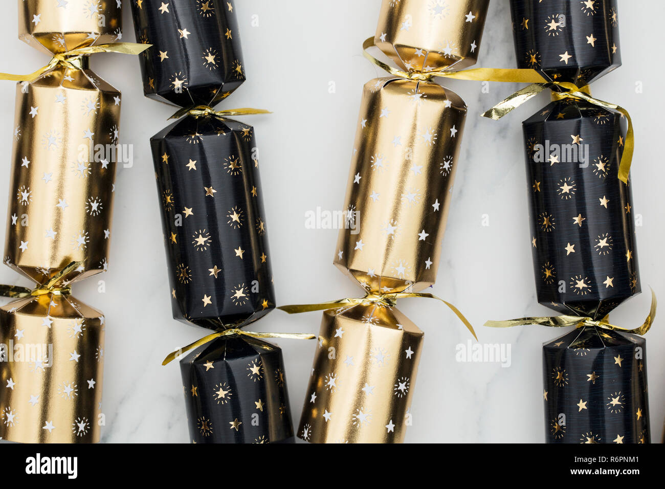 Christmas crackers. luxury gold and black festive crackers on a marble ...