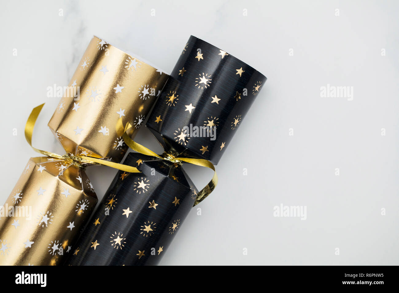 Christmas crackers. luxury gold and black festive crackers on a marble ...