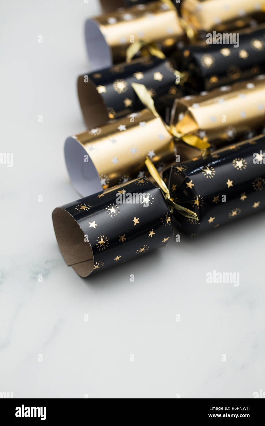 Christmas crackers. luxury gold and black festive crackers on a marble ...
