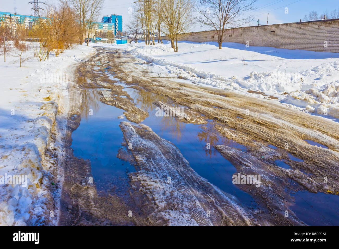 Holes and pothole on a rural road with snow Stock Photo - Alamy