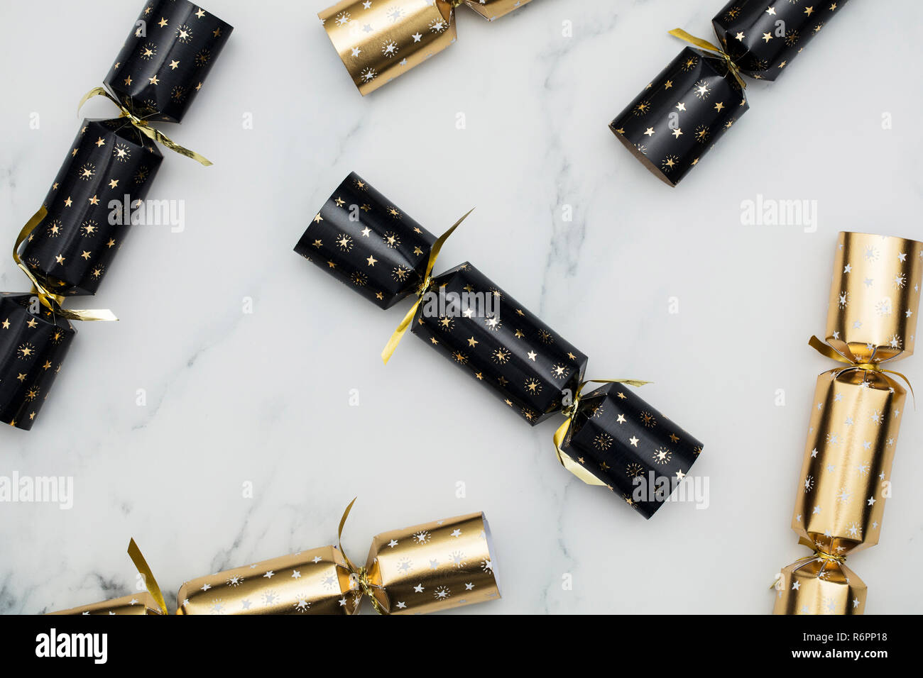 Christmas crackers. luxury gold and black festive crackers on a marble ...