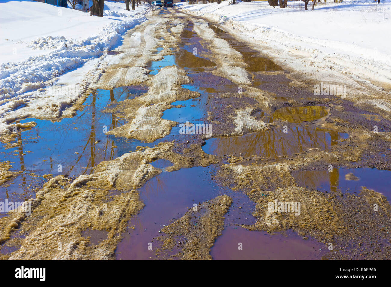 Holes and pothole on a rural road with snow Stock Photo - Alamy
