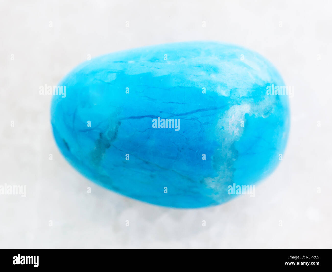 tumbled Turquenite (blue howlite) stone on white Stock Photo - Alamy