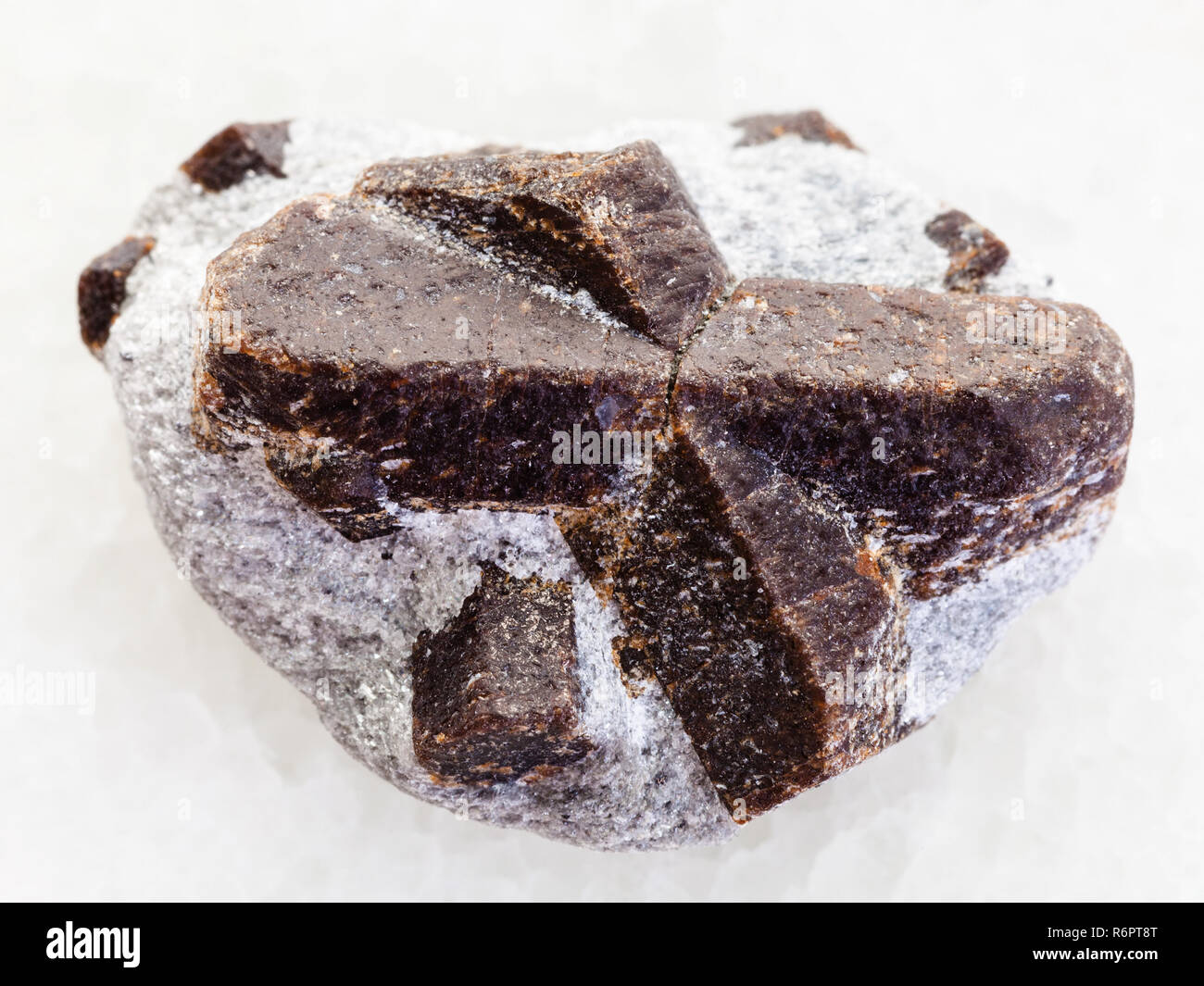 raw crystal of Staurolite in mica shale on white Stock Photo - Alamy