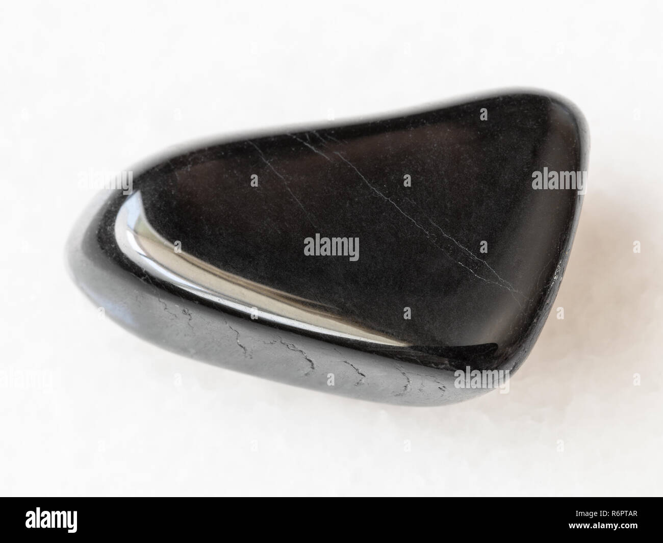 polished hawk-eye gemstone on white Stock Photo - Alamy