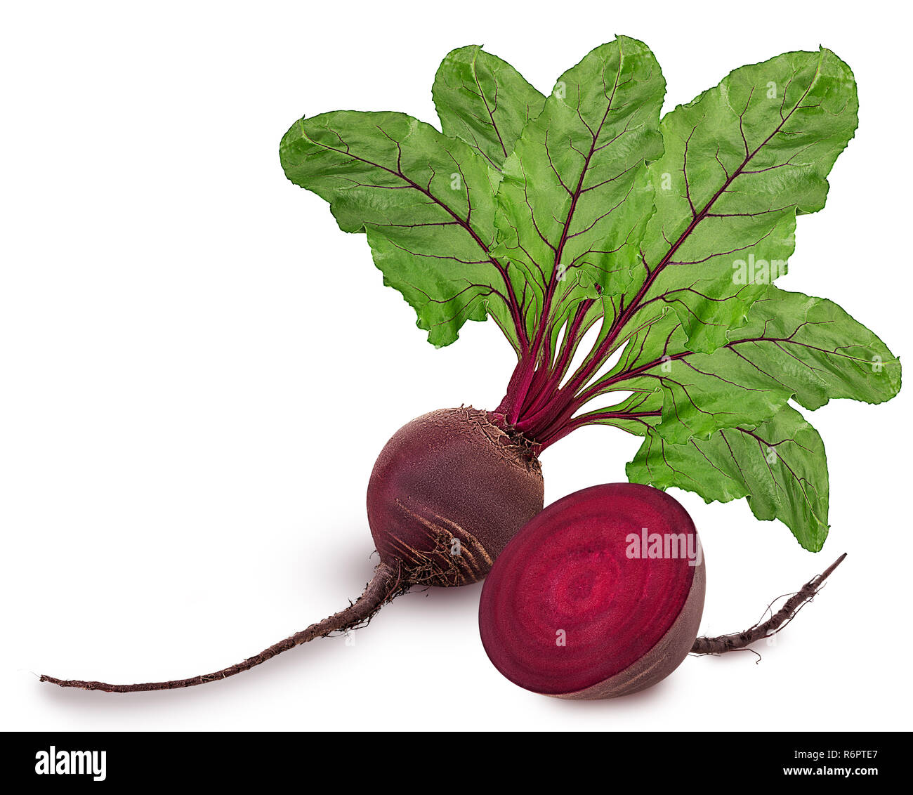 Fresh red beet root one whole and cut in half with green leaf isolated ...