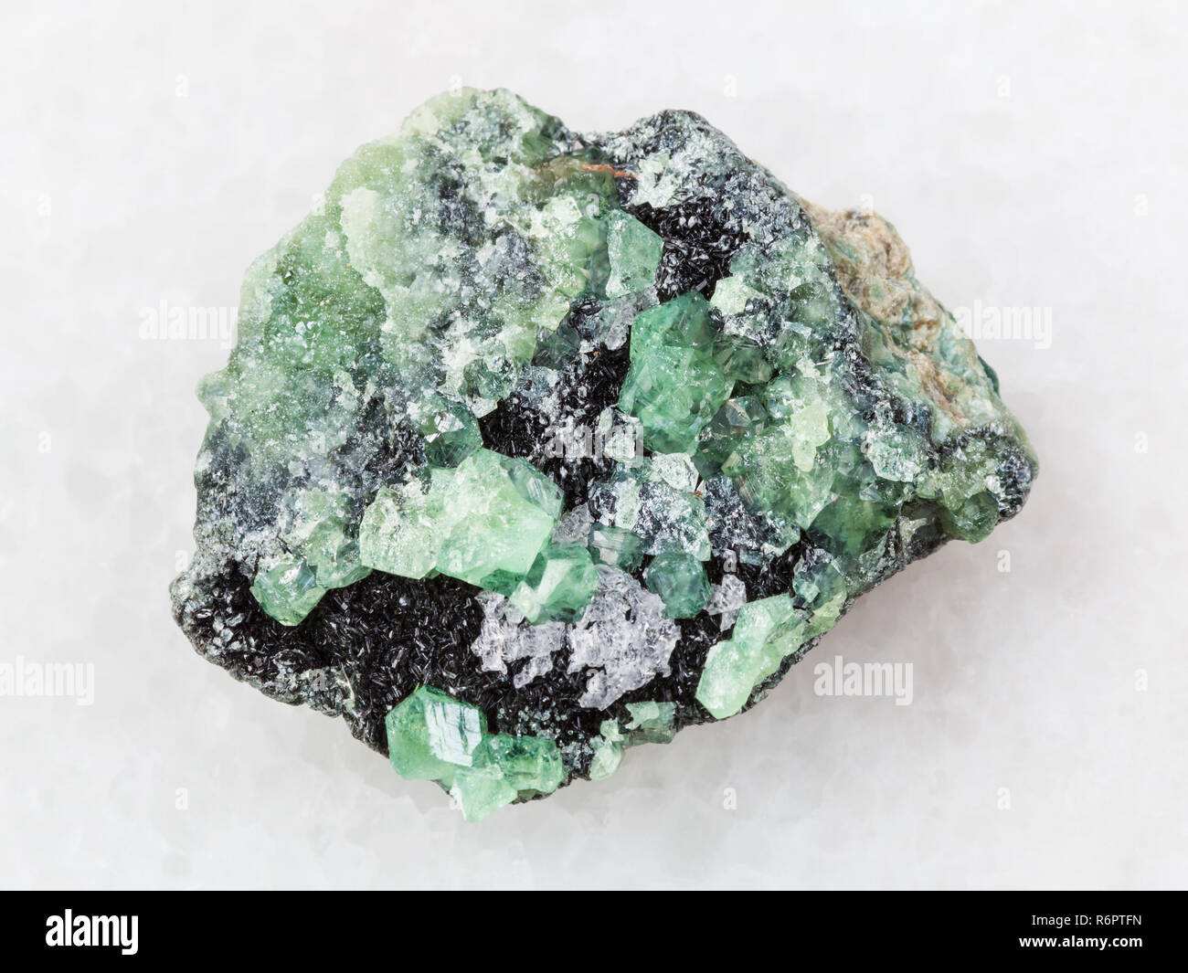 raw crystals of Demantoid garnet stone on white Stock Photo - Alamy