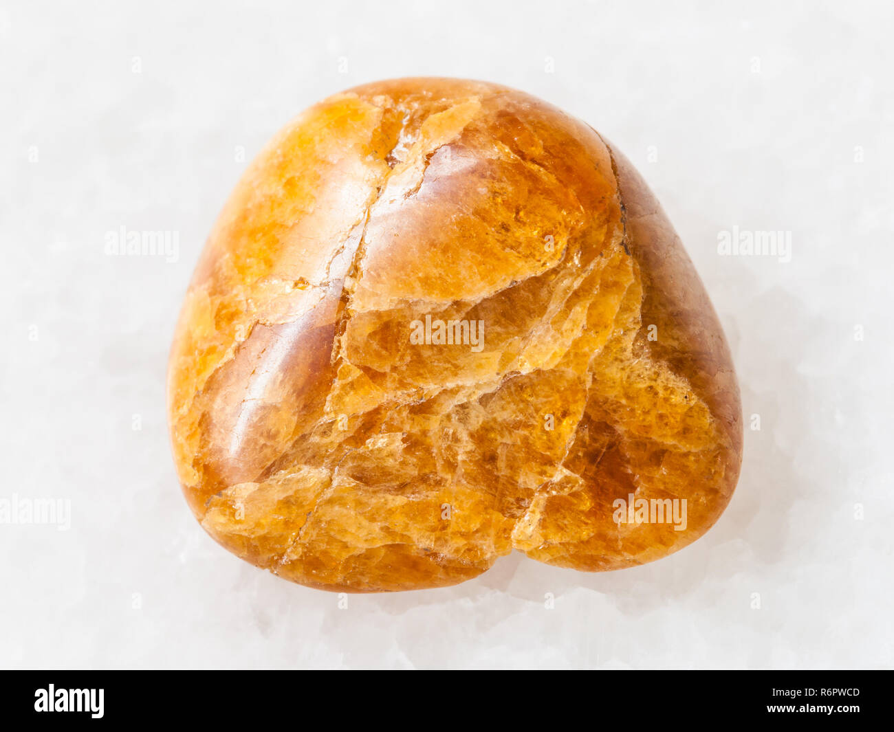 tumbled Clinohumite gemstone on white Stock Photo - Alamy