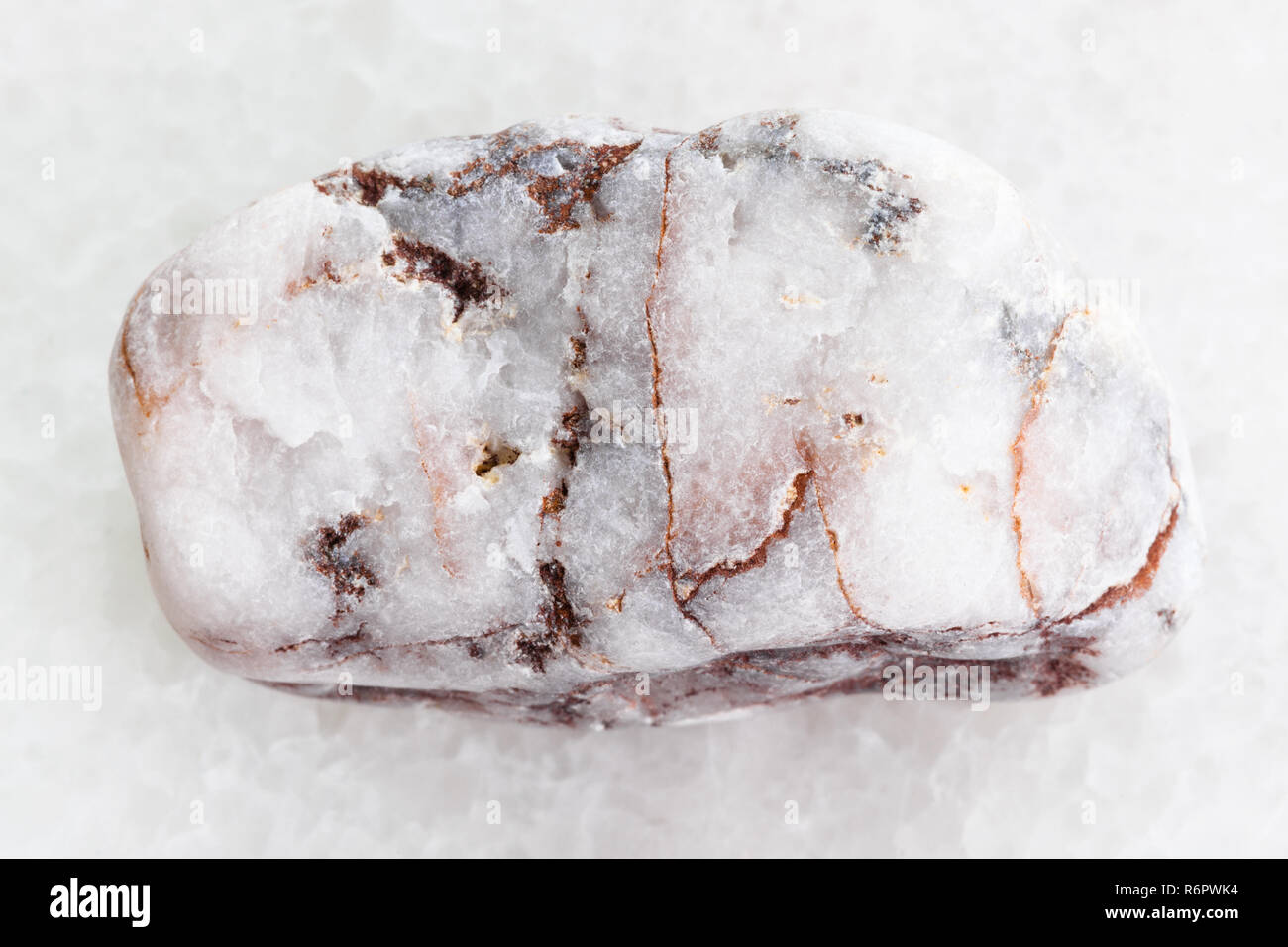 tumbled marble gem on white marble Stock Photo - Alamy