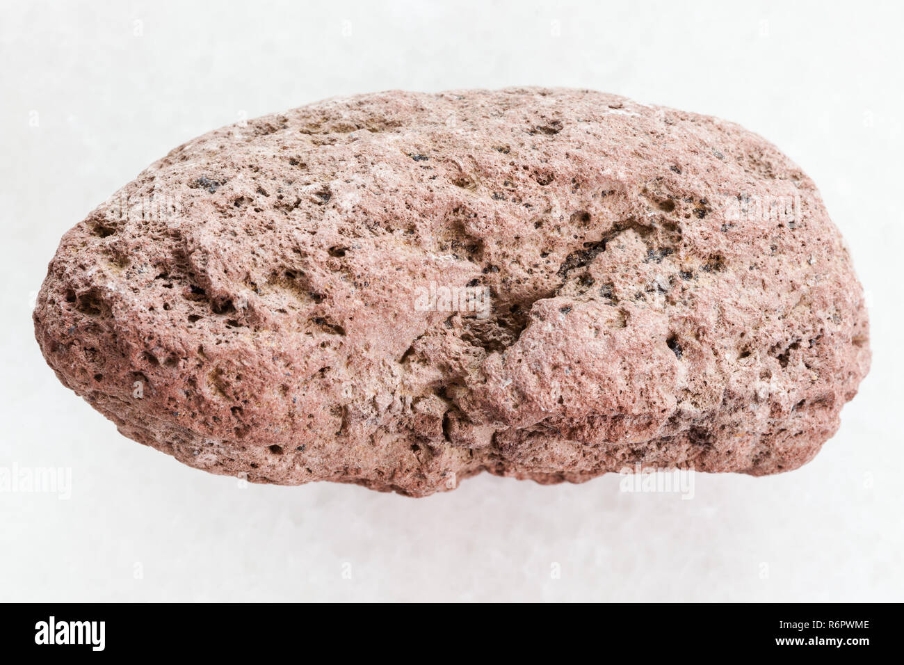 pebble of red pumice stone on white marble Stock Photo - Alamy