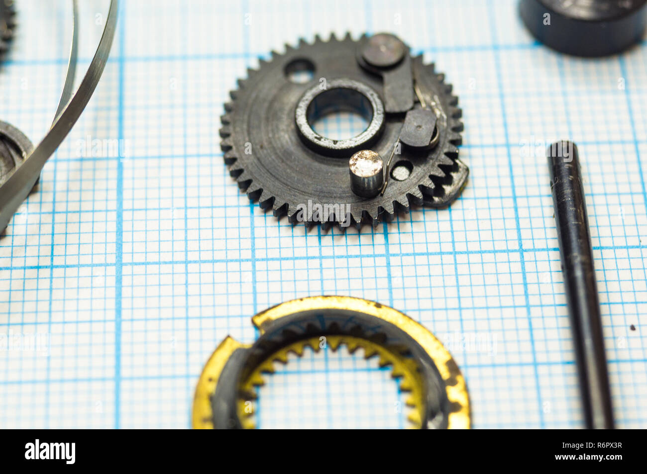 parts are completely disassembled old retro film SLR camera on graph ...