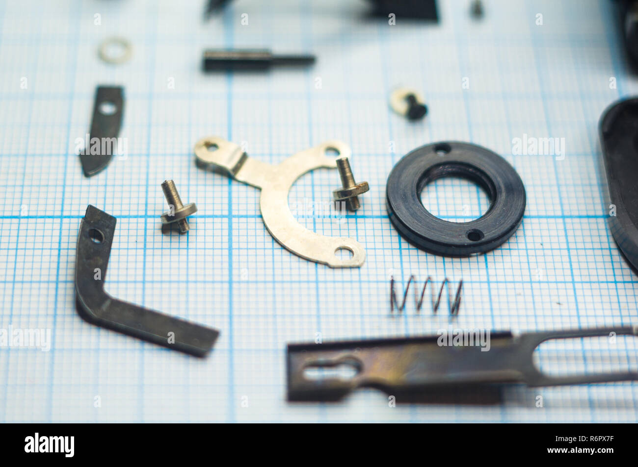 parts are completely disassembled old retro film SLR camera on graph ...