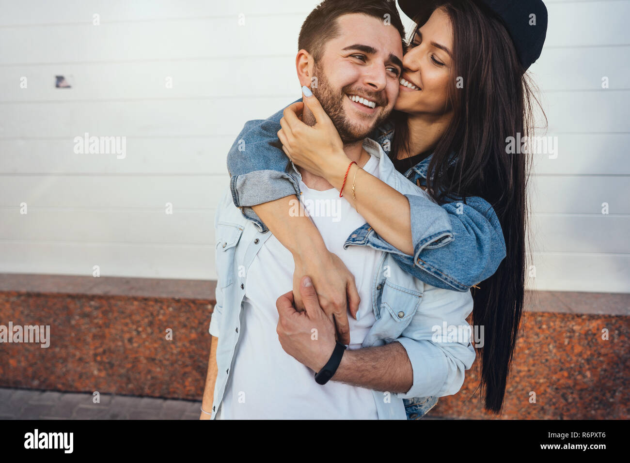 Young beautiful girl hugging her handsome boyfriend Stock Photo - Alamy