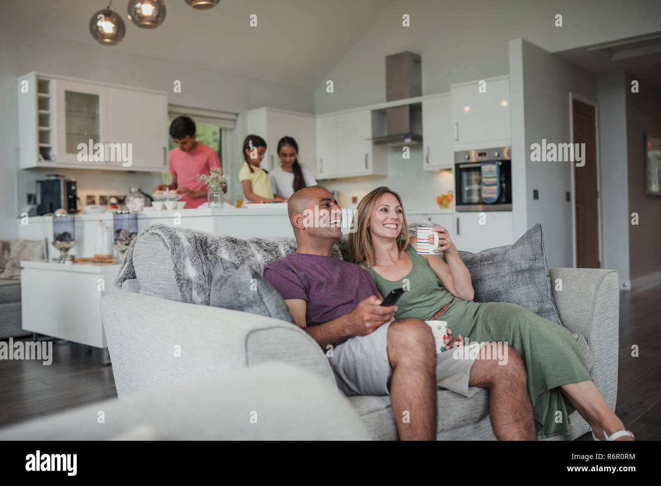 Merry family watching tv hi-res stock photography and images - Alamy