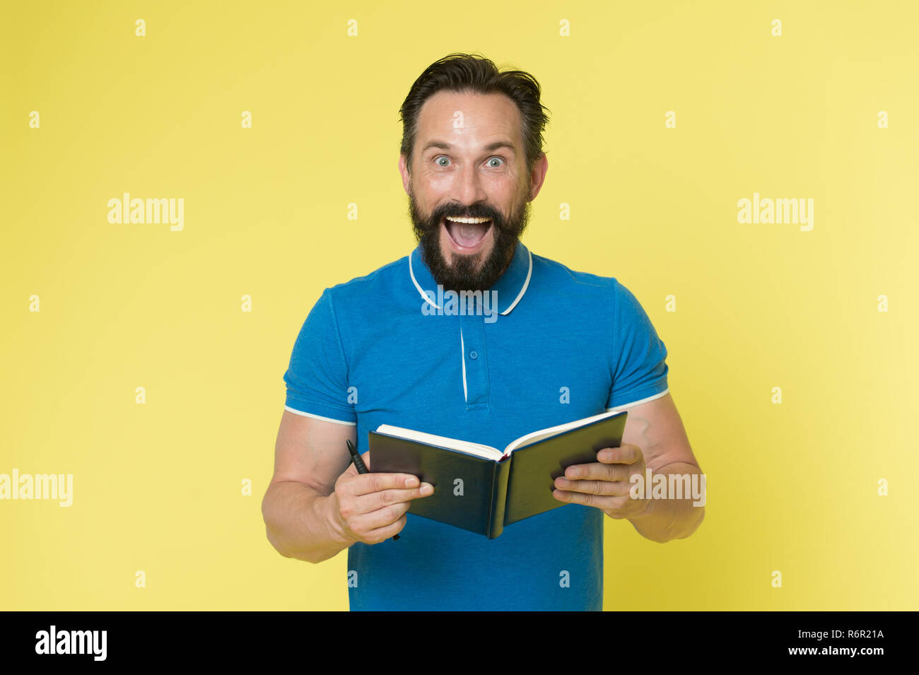 Great idea. Handsome inspired mature man holds notepad looking at ...