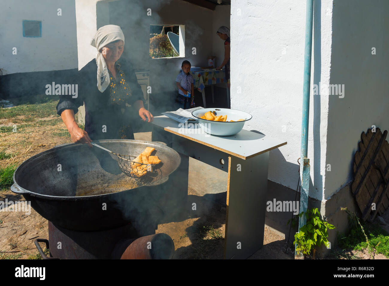 Kazakh Woman preparing the traditional local tandyr bread, Shymkent ...