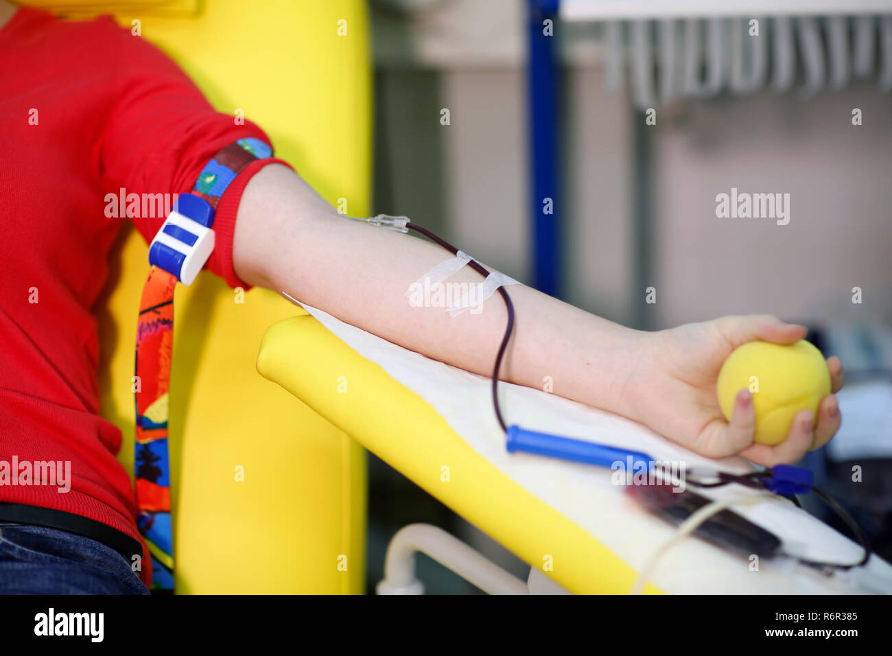 Patient with an infusion needle taking a blood sample at the ...