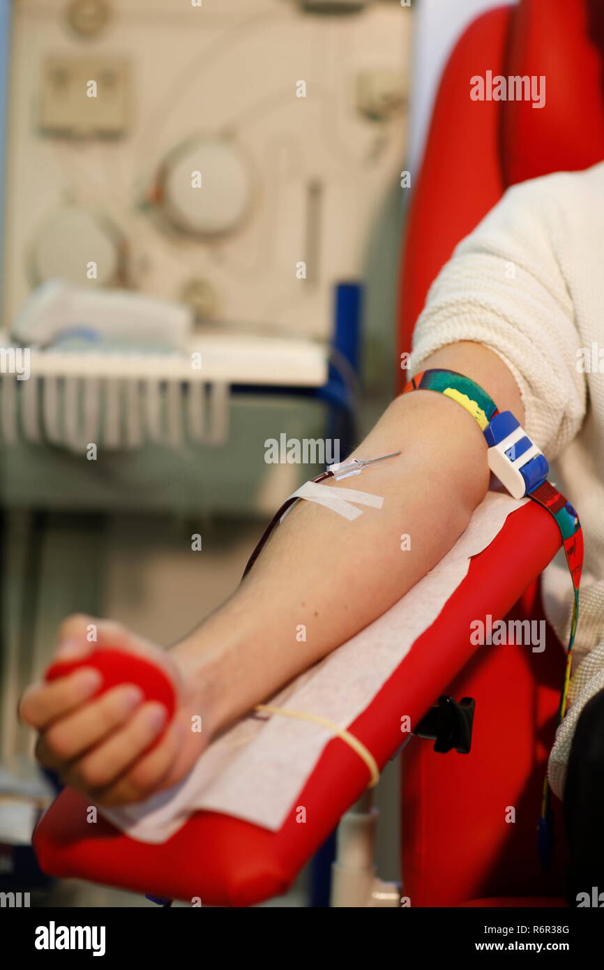 Patient with an infusion needle taking a blood sample at the ...