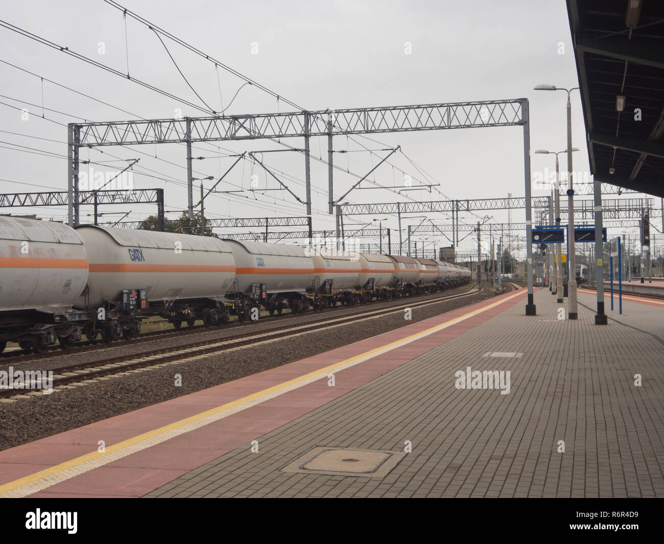 The railway station in Malbork Poland, pasing train transporting ...