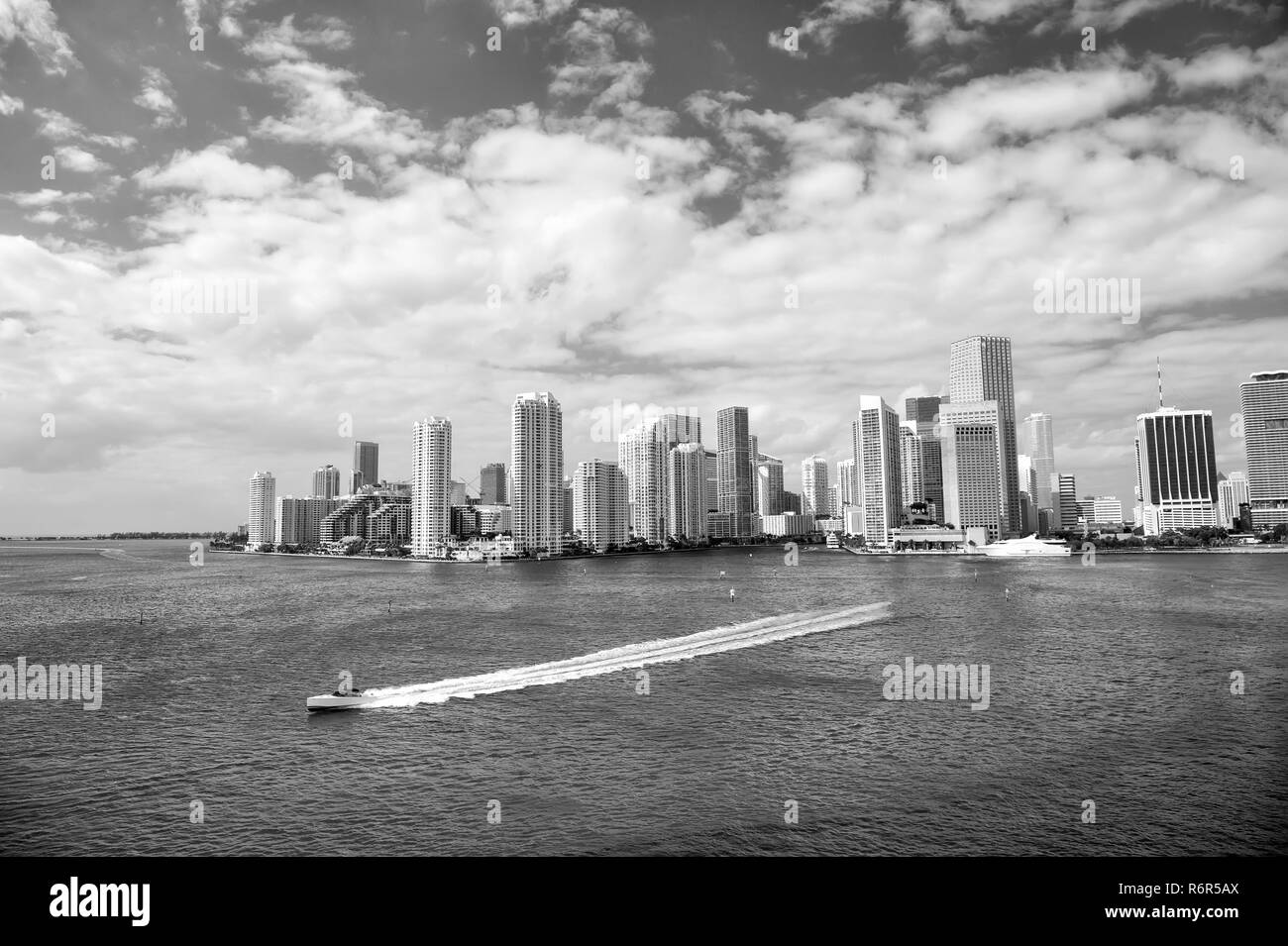 Miami skyscrapers with blue cloudy sky,white boat sailing next to Miami ...