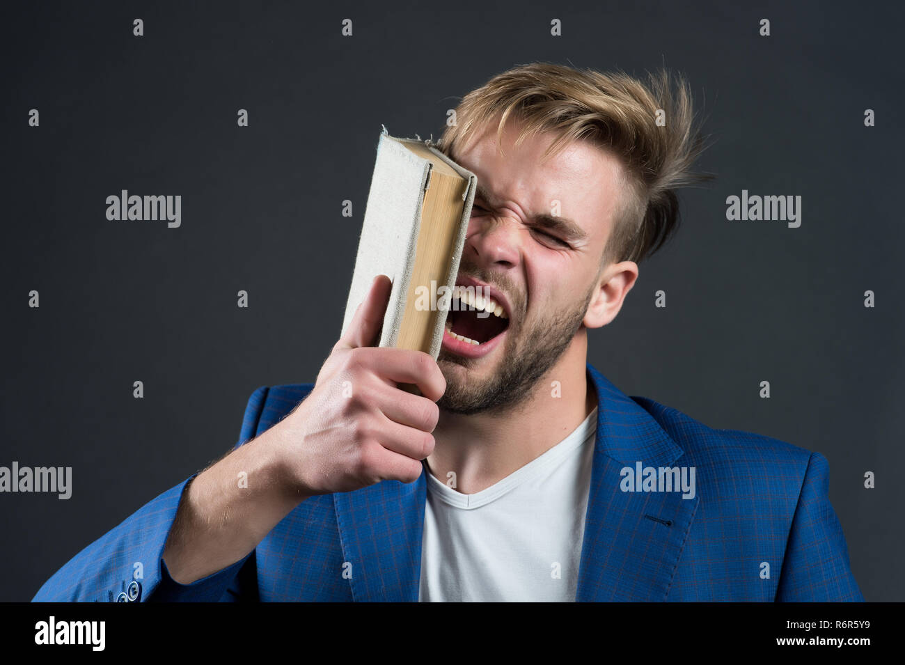 Man beat face with book, motivation. Angry businessman shout with book ...