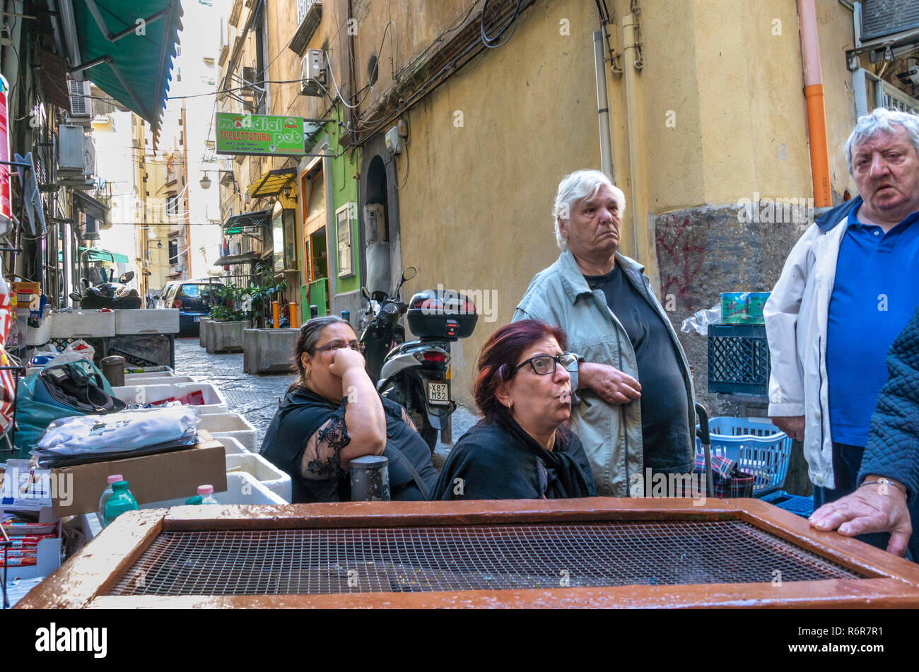 Local residents conversing at a strret vendors stall on the Vico ...