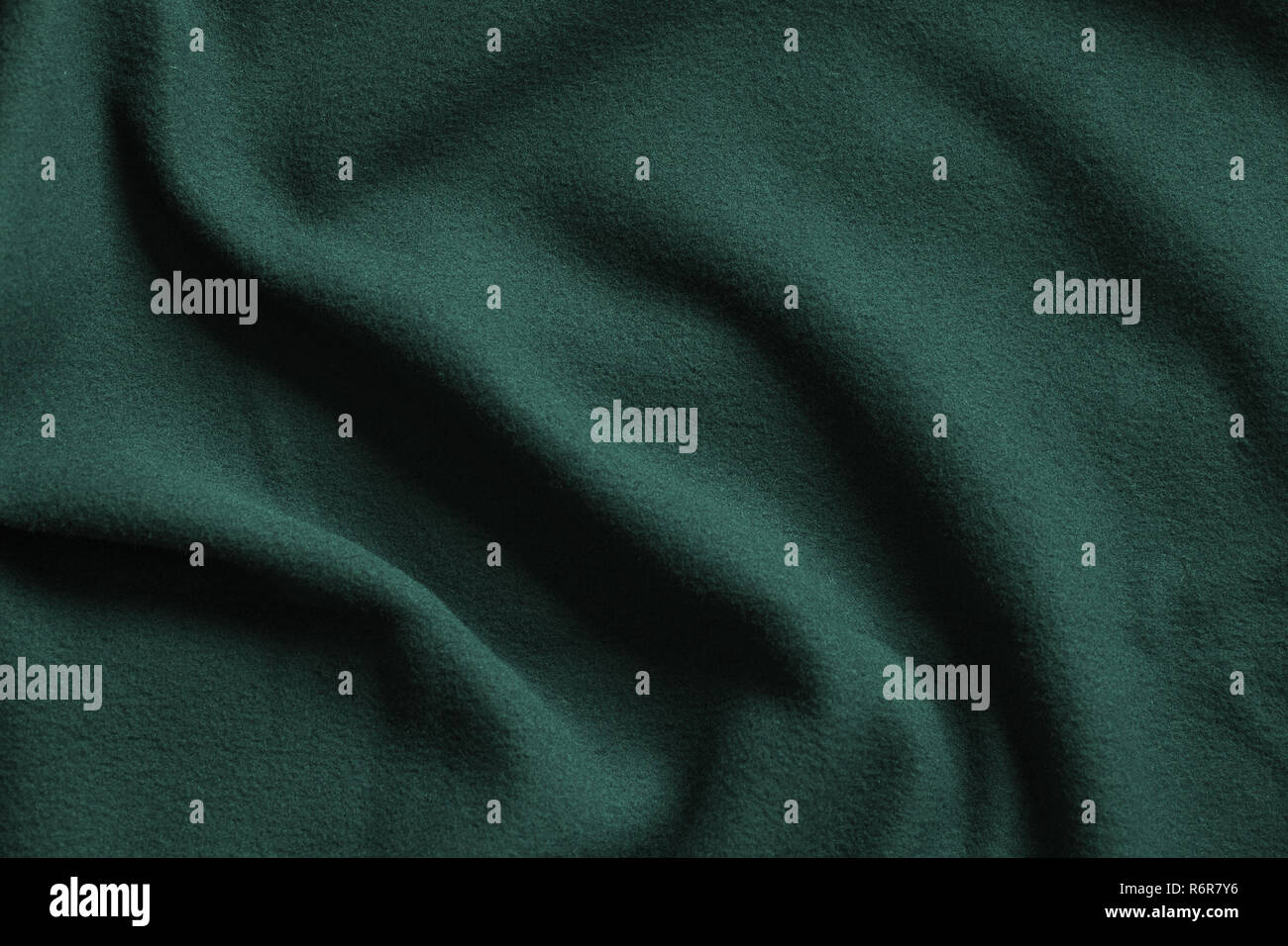 Texture of dark green fleece, soft napped insulating fabric made from ...