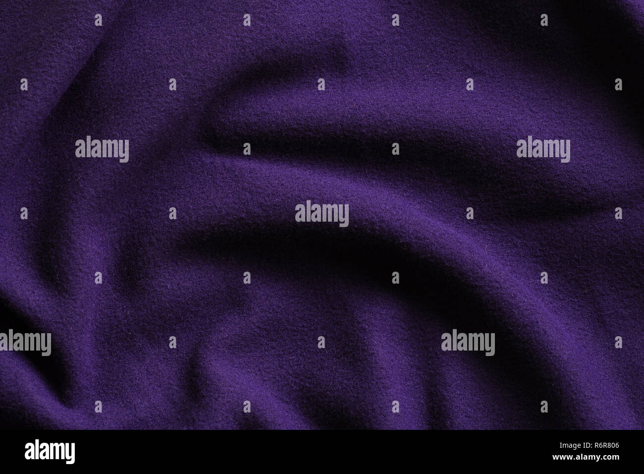 Texture of deep purple fleece, soft napped insulating fabric made from ...