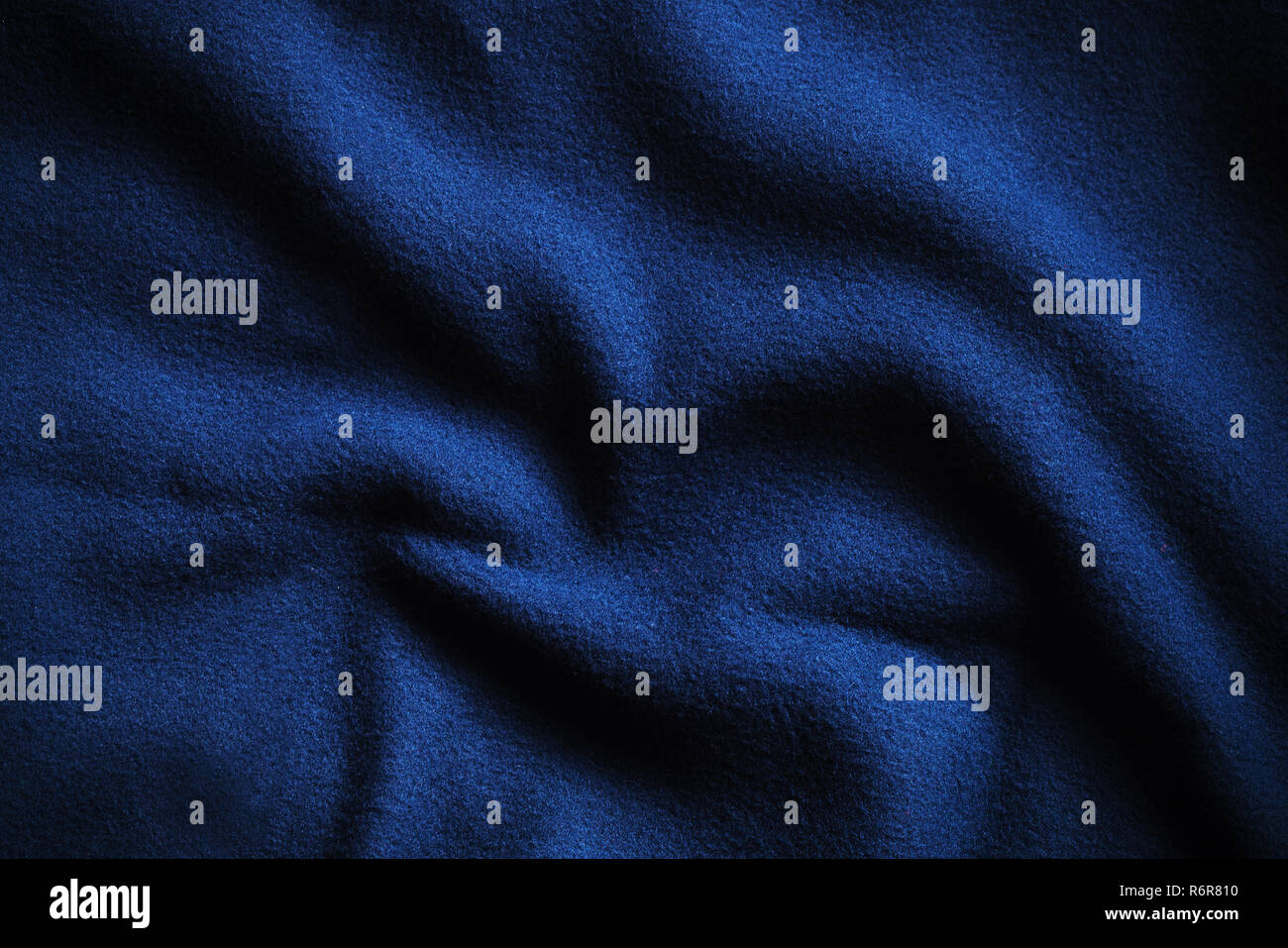Texture of deep blue fleece, soft napped insulating fabric made from ...