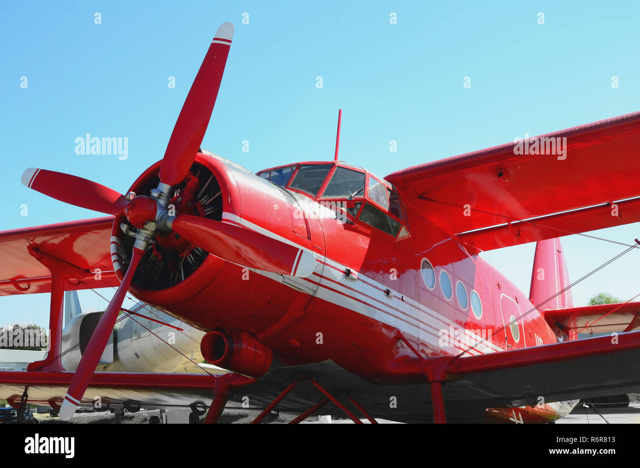 Big red airplane with white stripes Stock Photo - Alamy