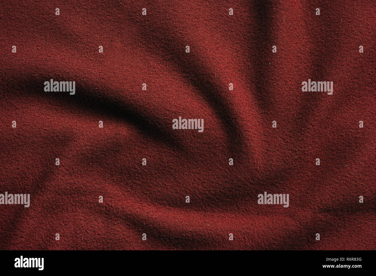 Texture of red fleece, soft napped insulating fabric made from ...