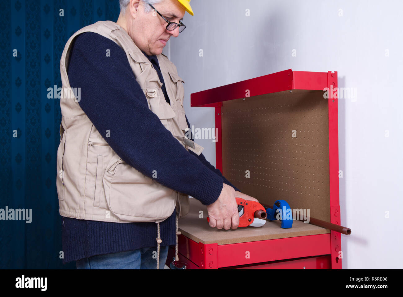 plumber at work on his workbench to fit pipes Stock Photo - Alamy
