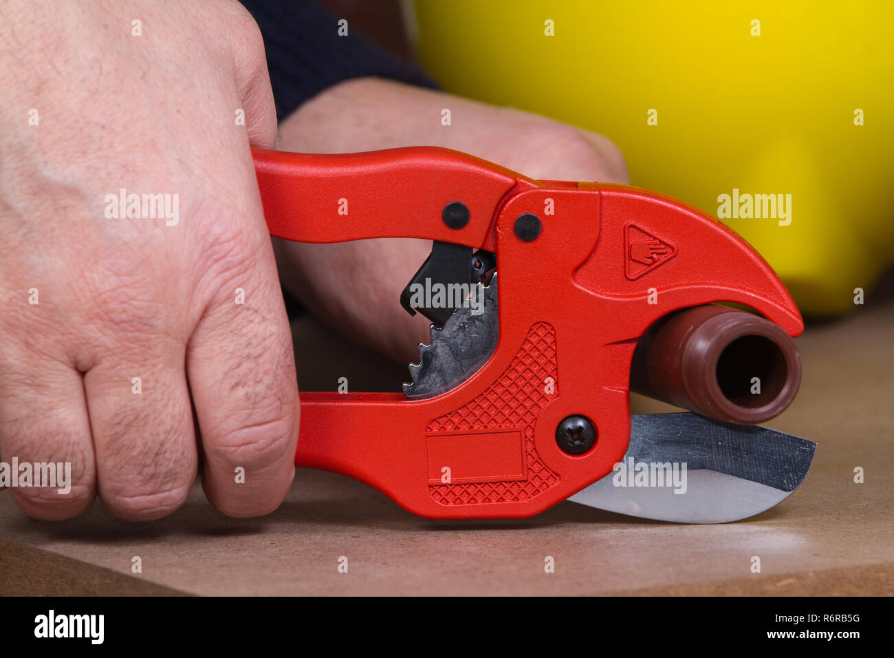plumber at work on his workbench to fit pipes Stock Photo - Alamy