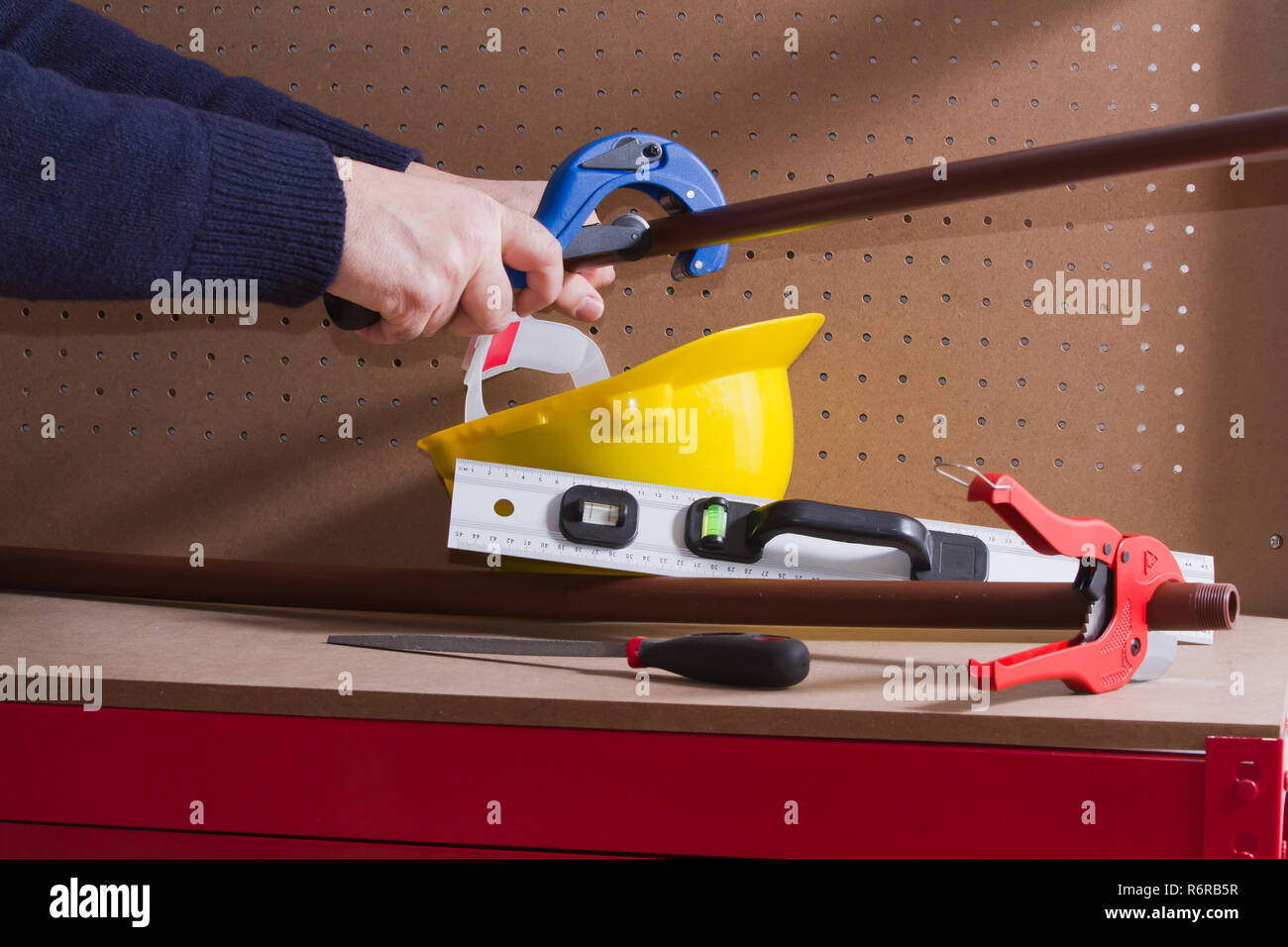 plumber at work on his workbench to fit pipes Stock Photo - Alamy