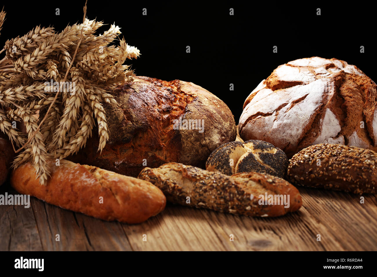 Different kinds of bread and bread rolls on board from above. Kitchen ...