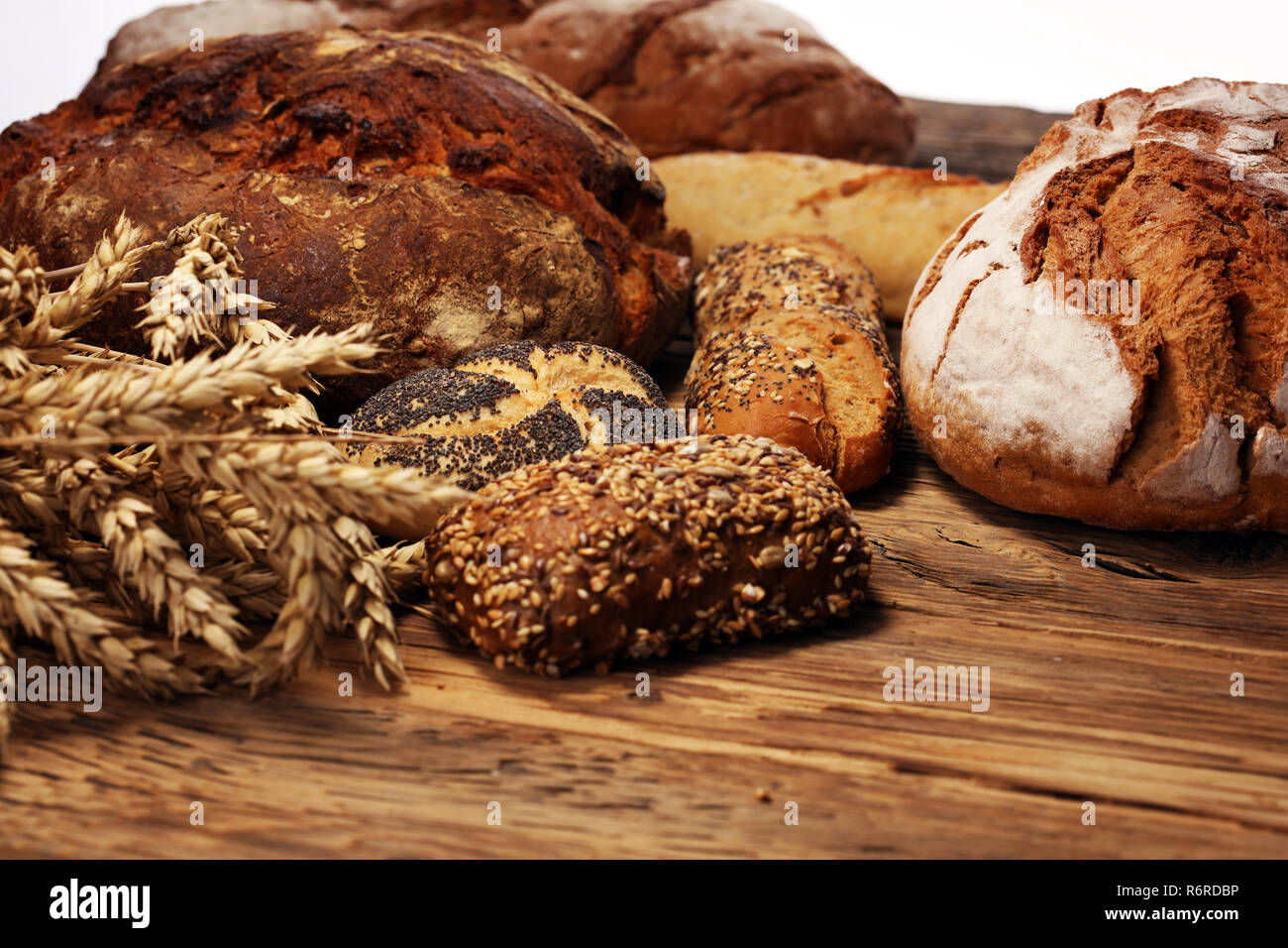 Different kinds of bread and bread rolls on board from above. Kitchen ...